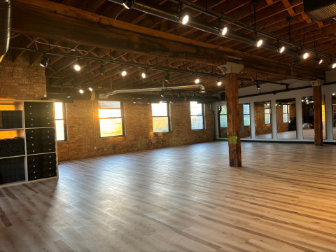 Beautiful timber loft fitness studio with equipment, skyline view and ...