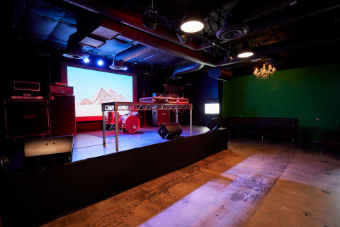 Modern Bar With Music Decor and Large Stage, Backlined Instruments ...