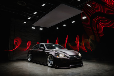 Sleek, modern, industrial, blacked-out studio with large overhead soft ...