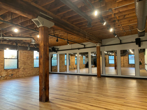 Beautiful timber loft fitness studio with equipment, skyline view and ...