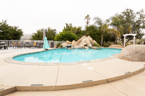 Spacious resort style backyard with pool, fireplace and barbeques ...