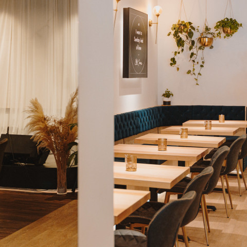 Modern minimalist open-concept restaurant with a live stage and elegant ...