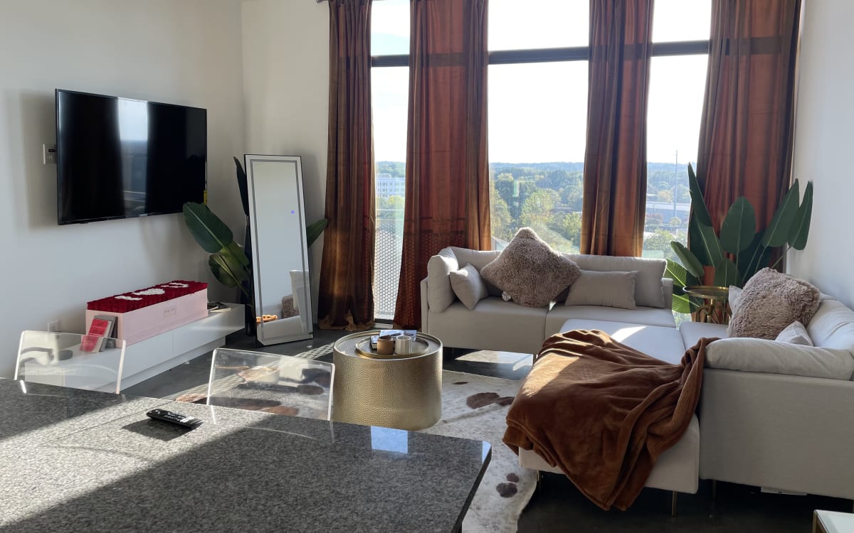 Lofty midtown apartment with floor to ceiling windows and a lot of ...