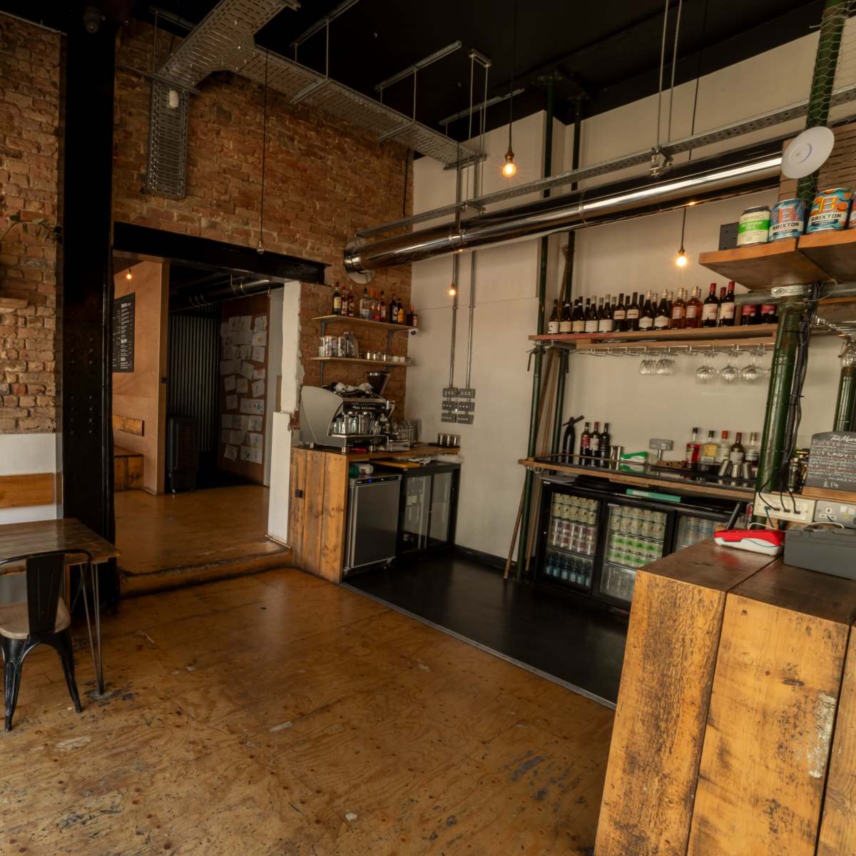 Rustic pizza restaurant with high ceilings and windows spanning the ...