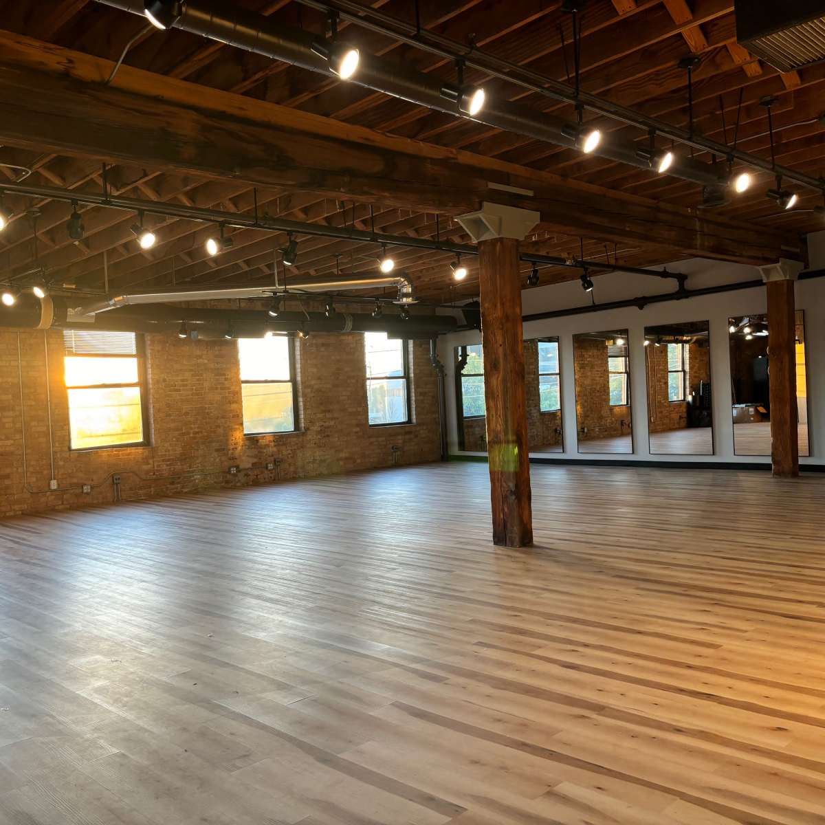 Beautiful timber loft fitness studio with equipment, skyline view and ...