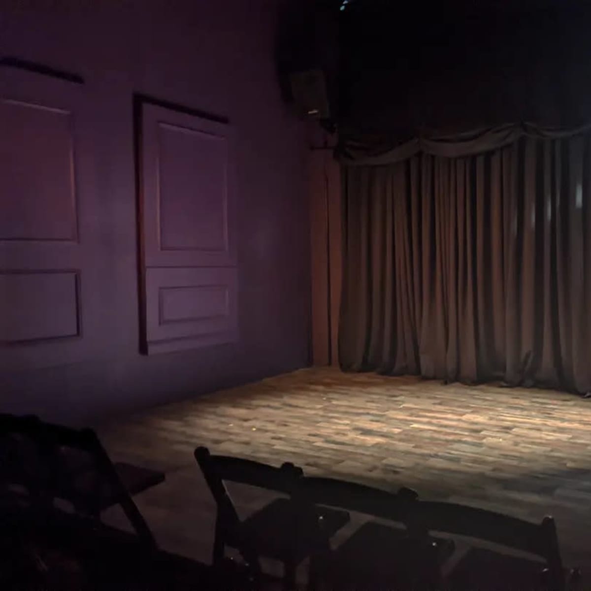 Indie Theater Space With Chandeliers, Stage Lights, and Purple Focus ...
