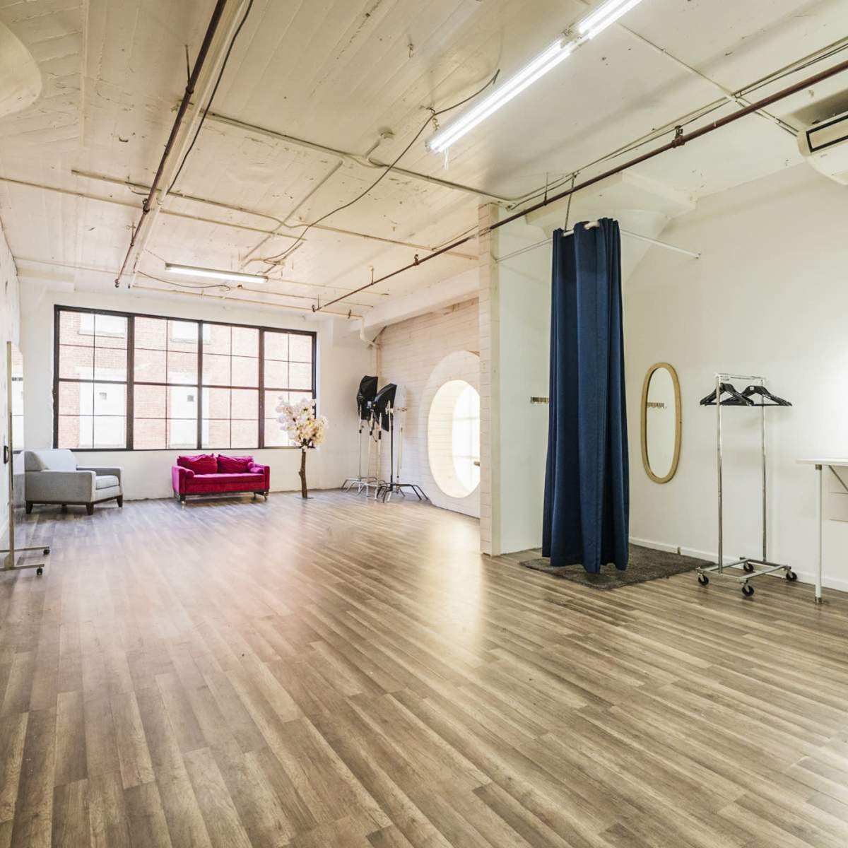 Beautiful photo studio with large round wood window, laminated floor ...