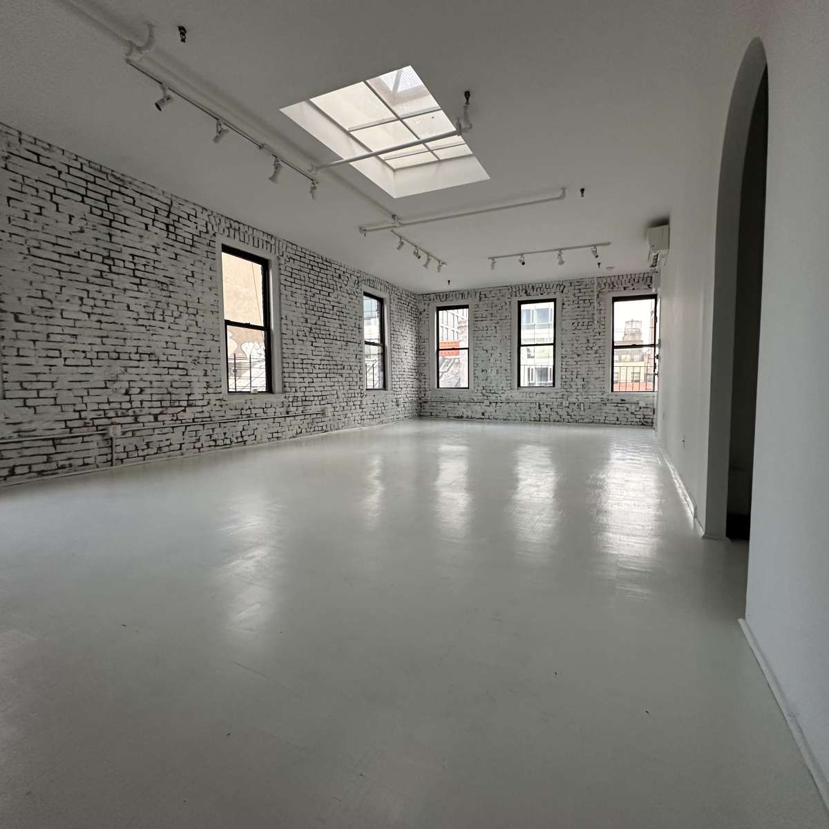 Artistic All-White Loft with Walls of Windows, Skylight & Unique Props ...