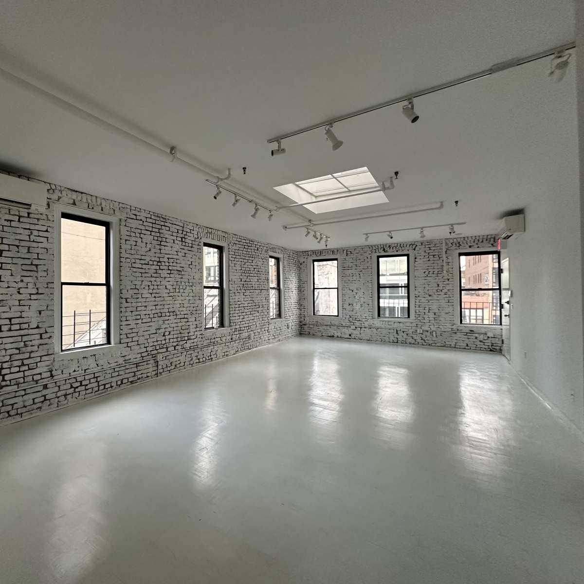 Multi-Use Artistic All-White Loft with Walls of Windows, Skylight ...