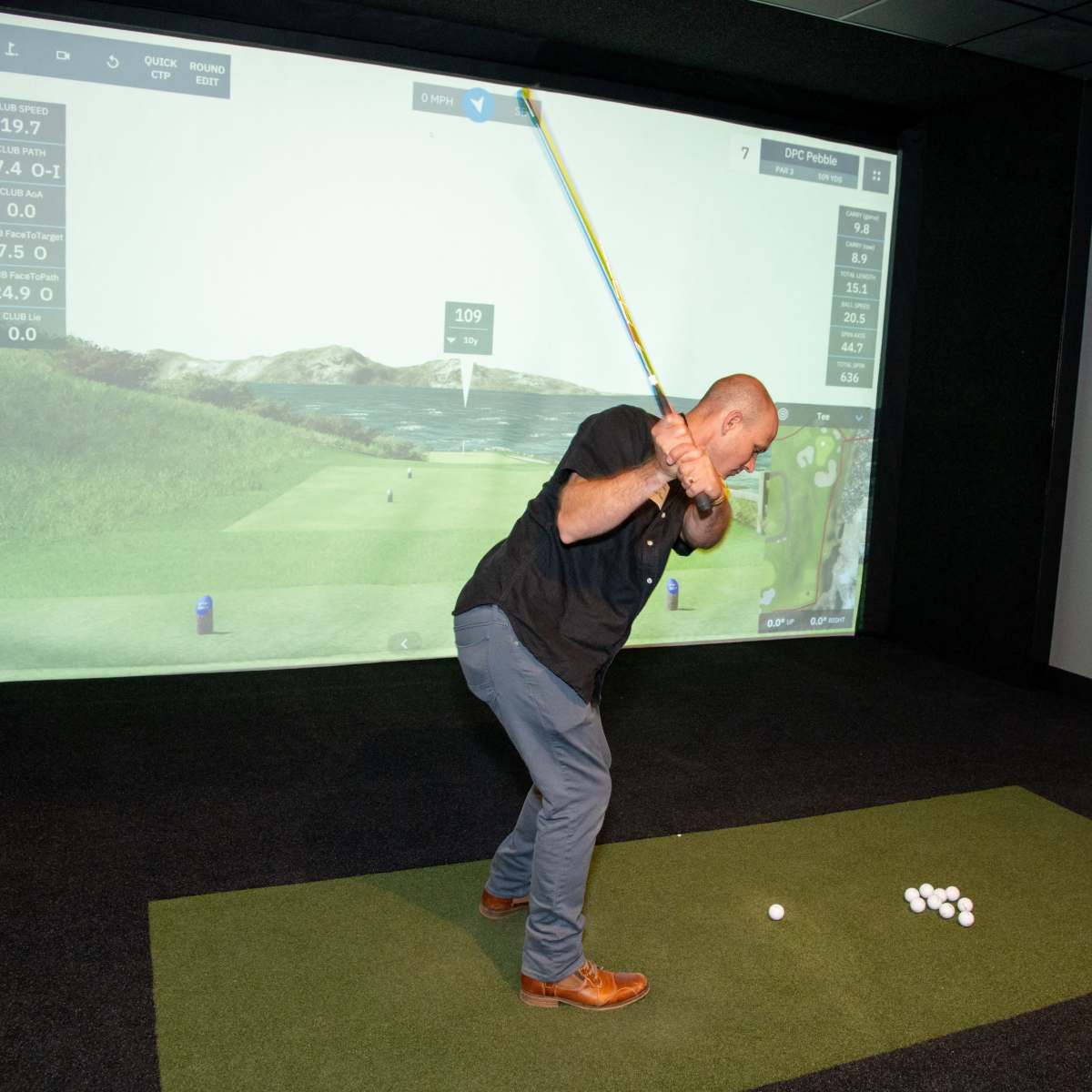 Urban flooring gallery space with a bar, entertainment patio, and golf ...