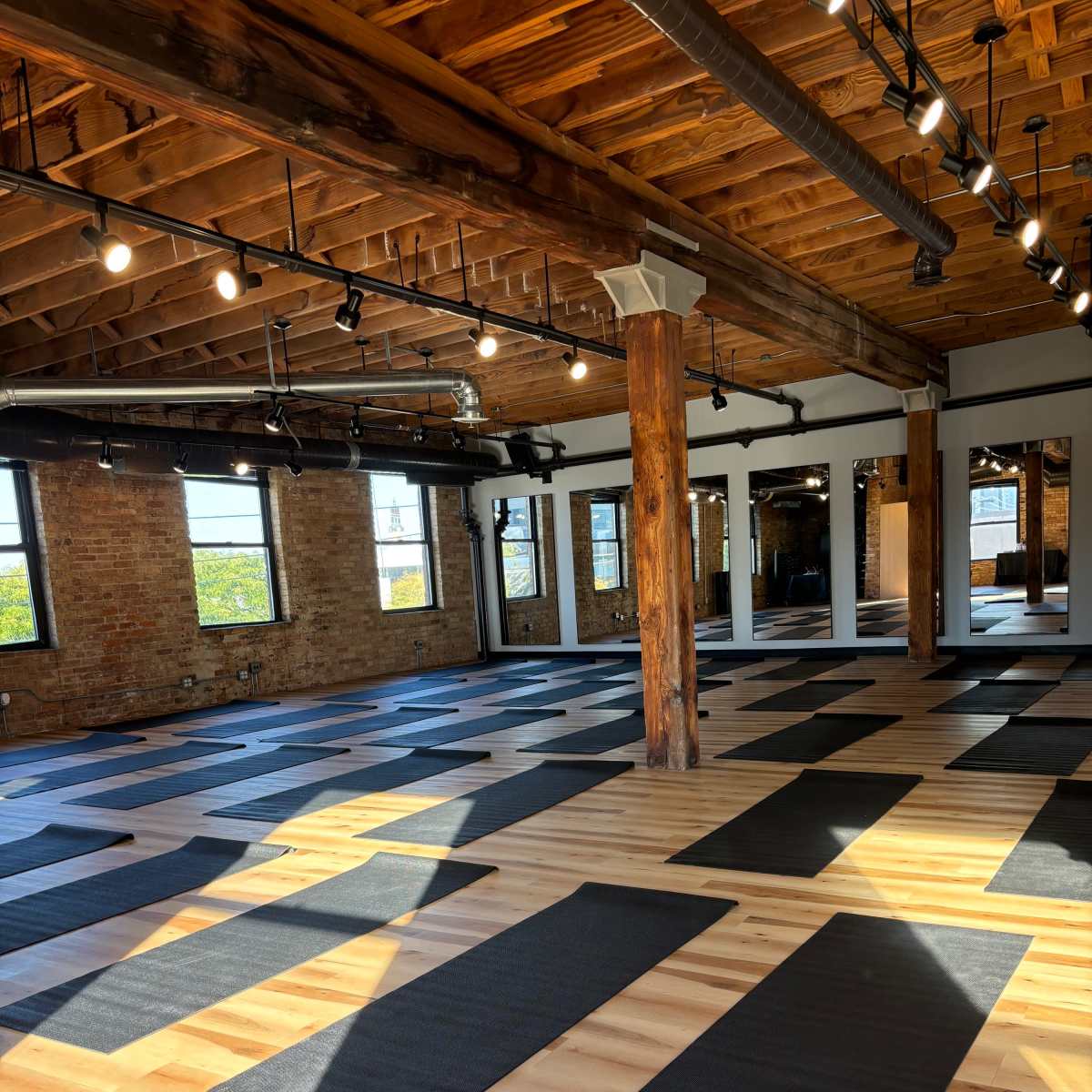 Beautiful timber loft fitness studio with equipment, skyline view and ...