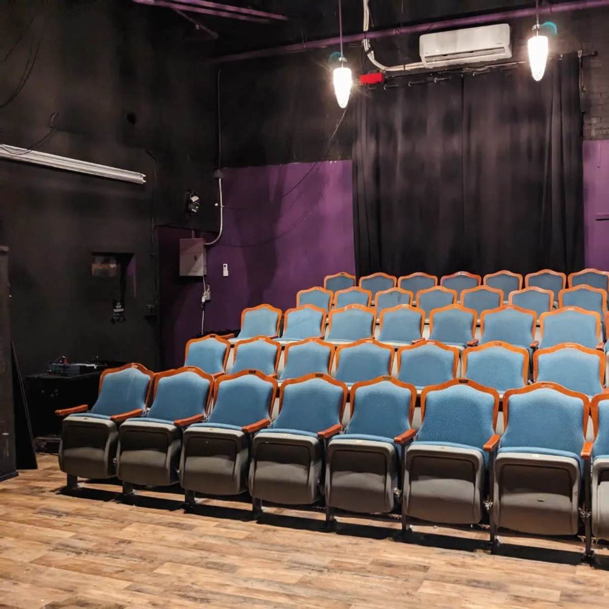 Indie Theater Space With Chandeliers, Stage Lights, and Purple Focus ...