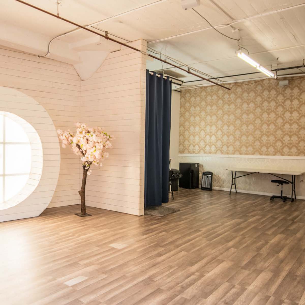 Beautiful photo studio with large round wood window, laminated floor ...