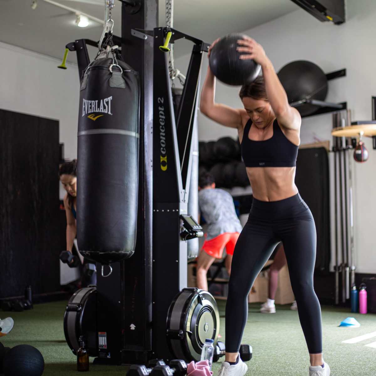 Training Gym with green turf, free weights, squat racks and other ...