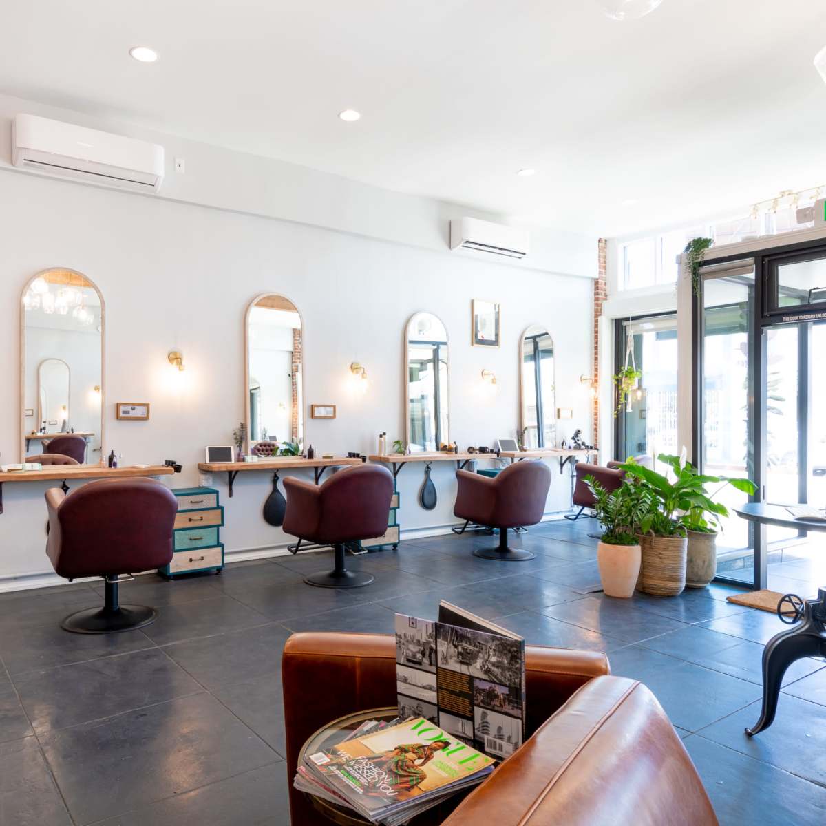 Large open gallery like salon space with brick and wood beams, high ...