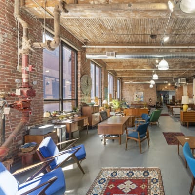 Industrial loft-style showroom filled with vintage mid-century modern ...