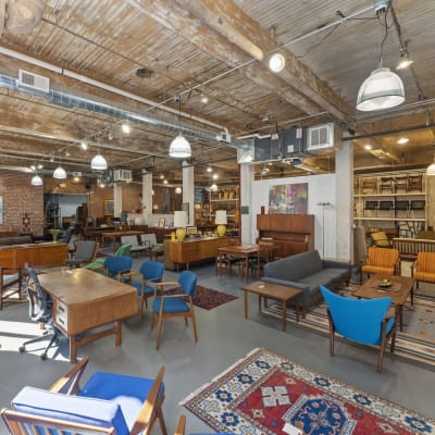 Industrial loft-style showroom filled with vintage mid-century modern ...