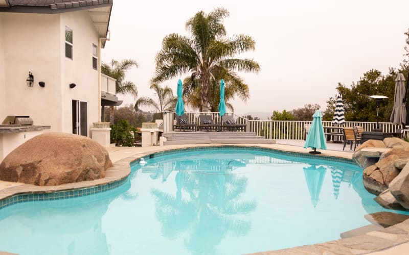 Spacious resort style backyard with pool, fireplace and barbeques ...