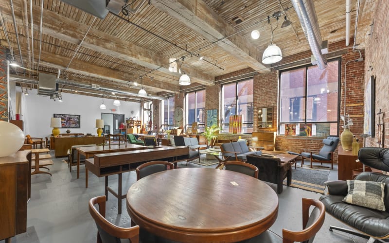 Industrial loft-style showroom filled with vintage mid-century modern ...