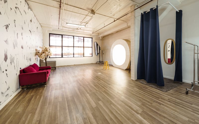 Beautiful photo studio with large round wood window, laminated floor ...