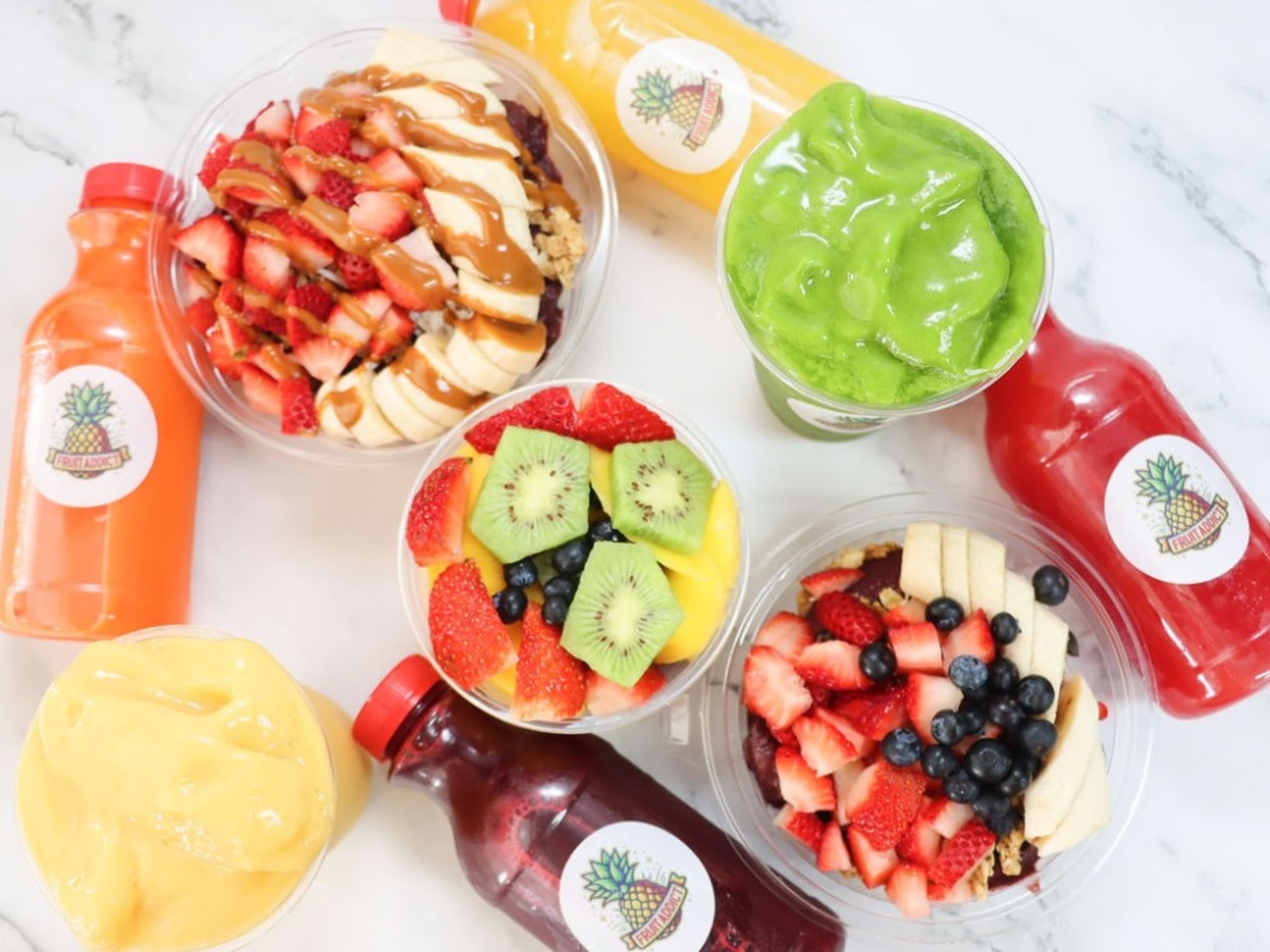 Fruit Addict Juice Bar | Open-Concept Juice Bar with Wood Bar, Greenery ...