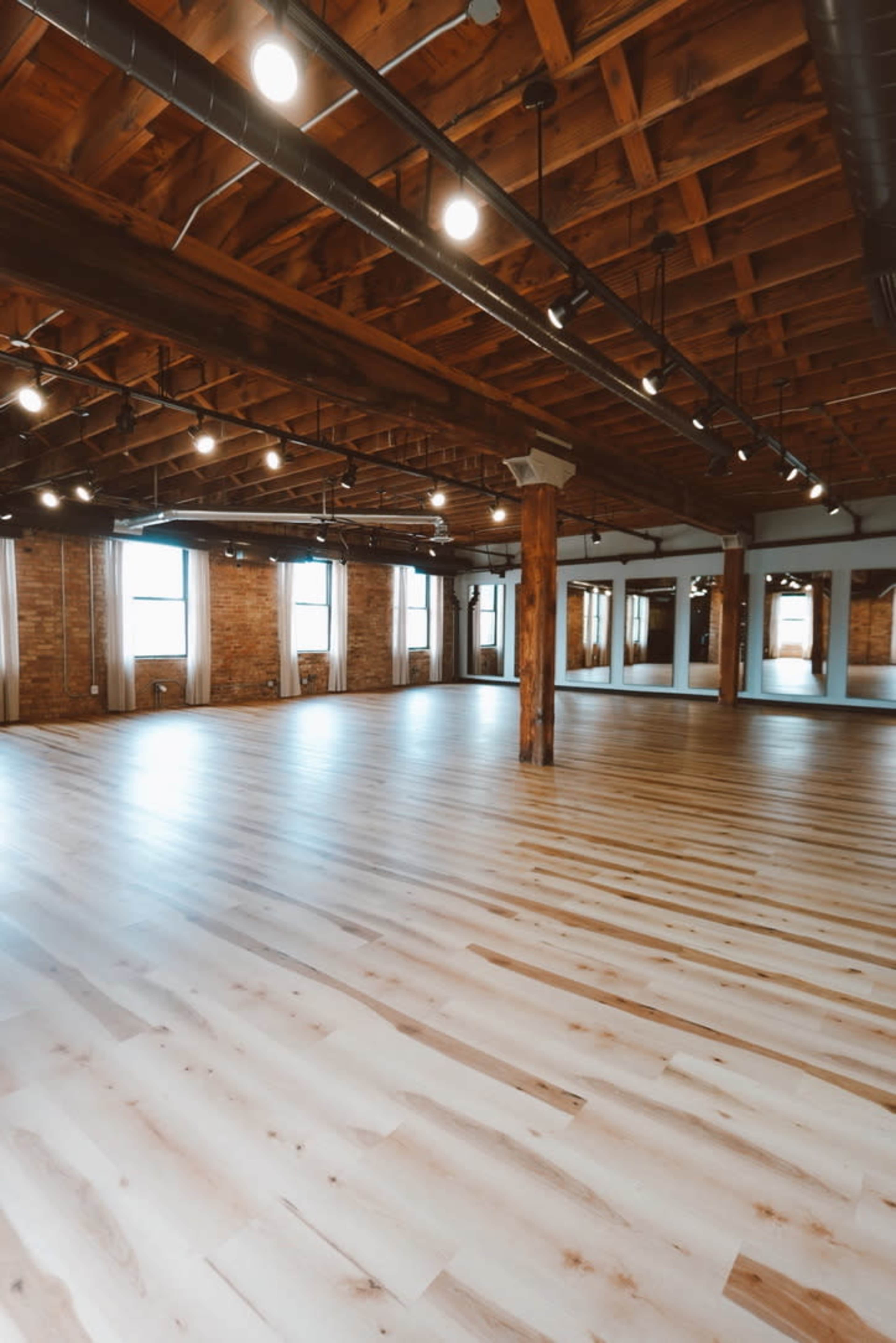 Beautiful timber loft fitness studio with equipment, skyline view and ...