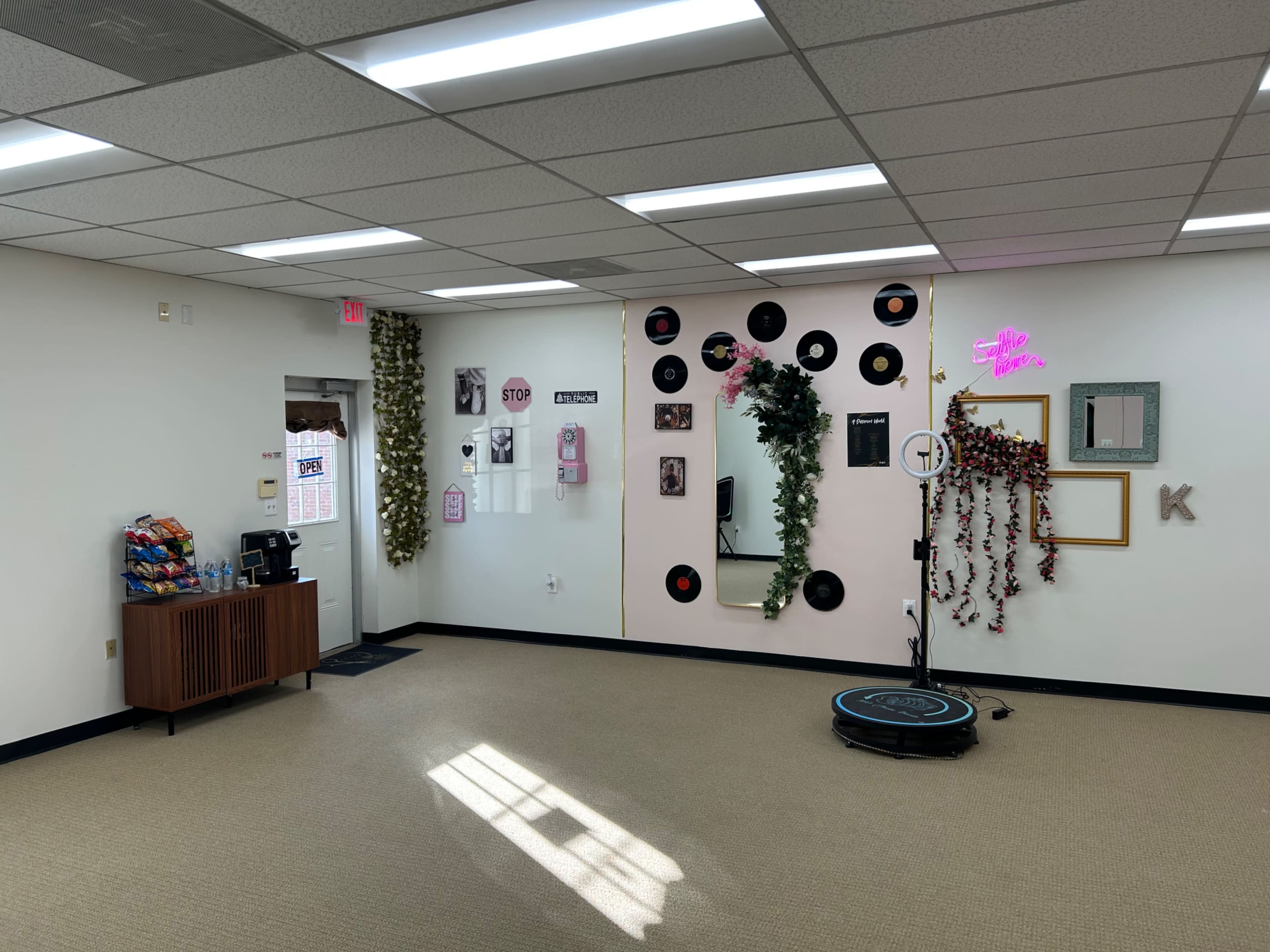 an intimate event space that features a custom selfie wall, located ...