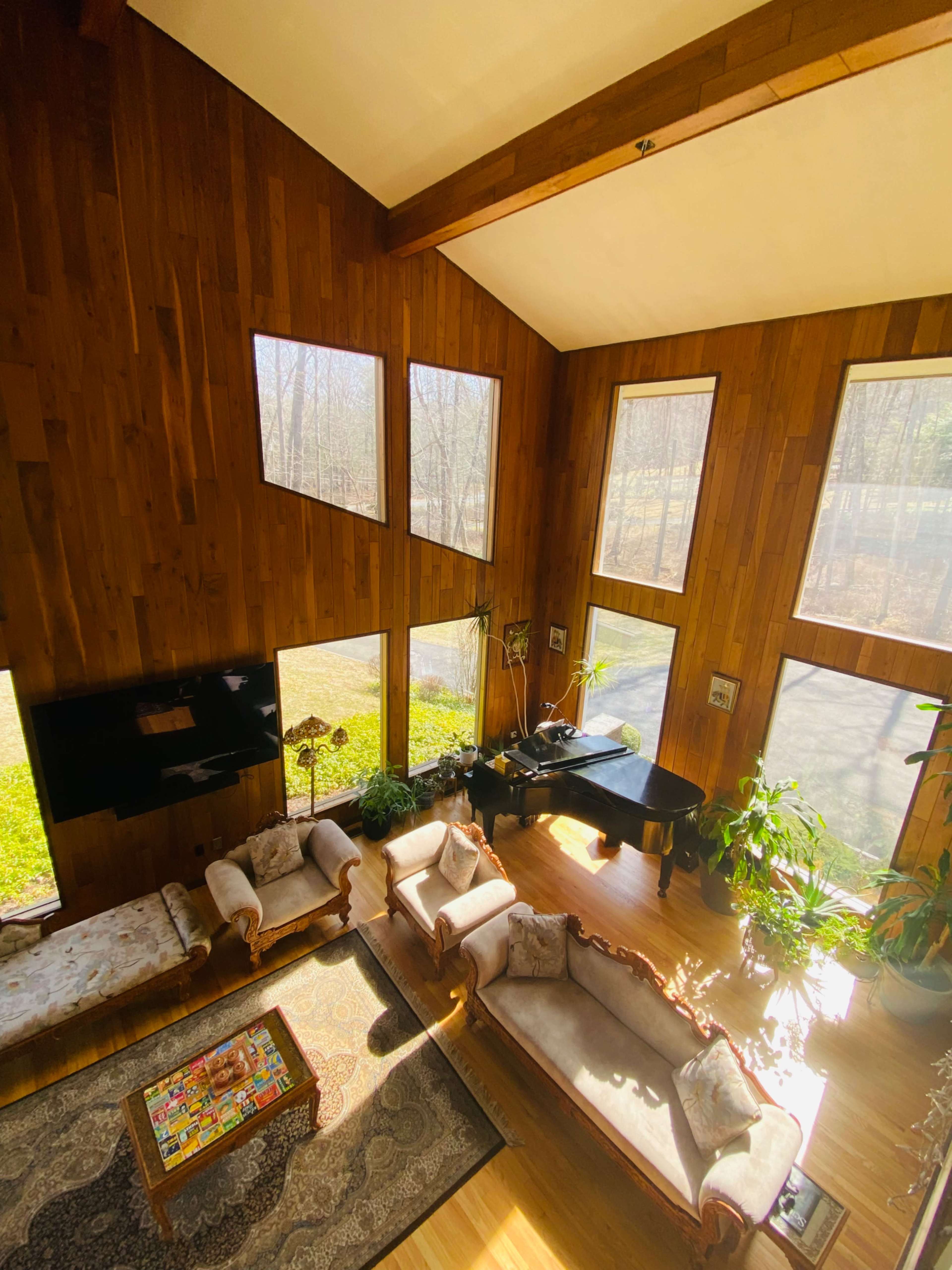 Rich Cedar Paneled Living Room with Expansive Floor to Ceiling Windows ...