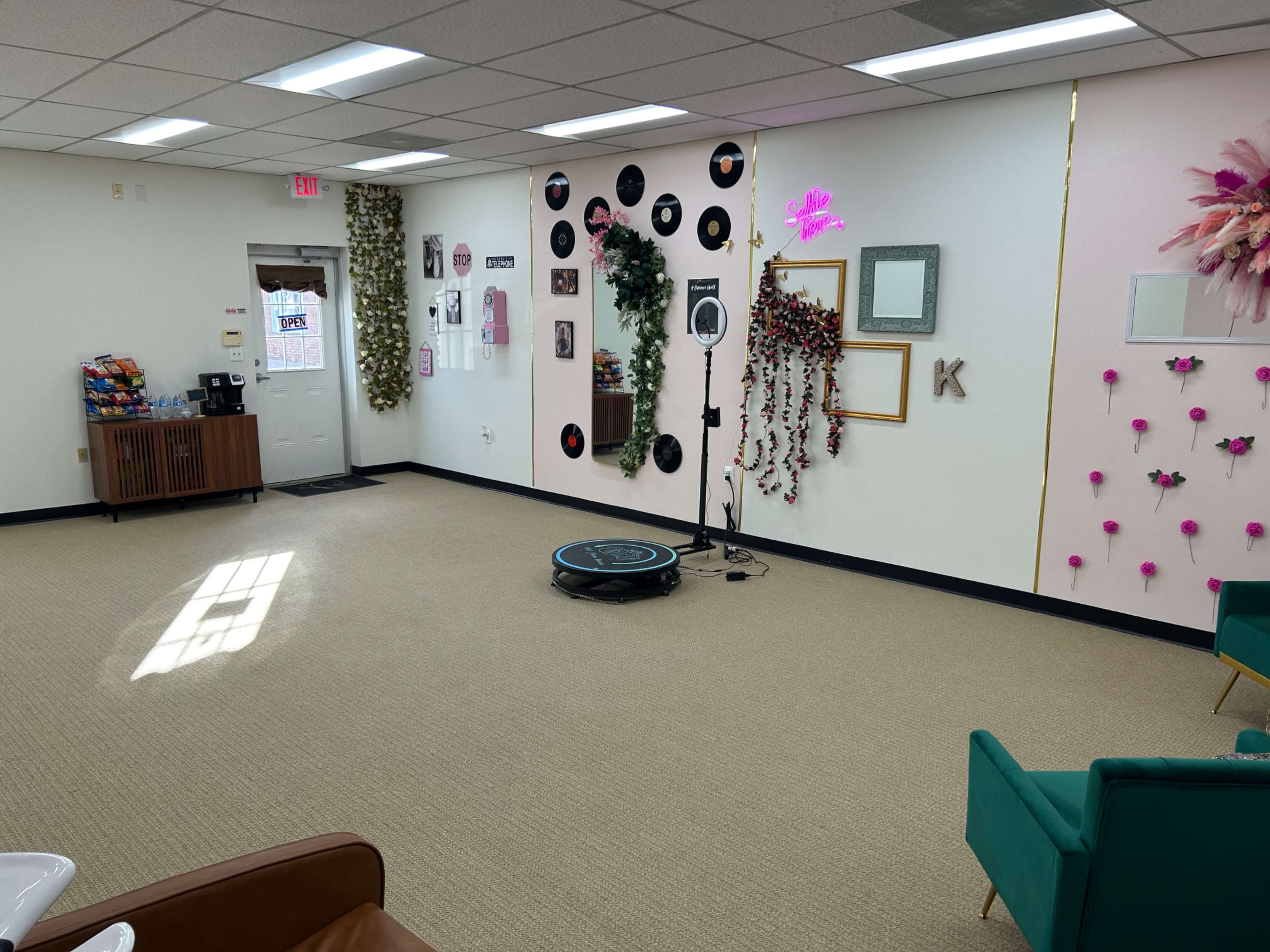 an intimate event space that features a custom selfie wall, located ...