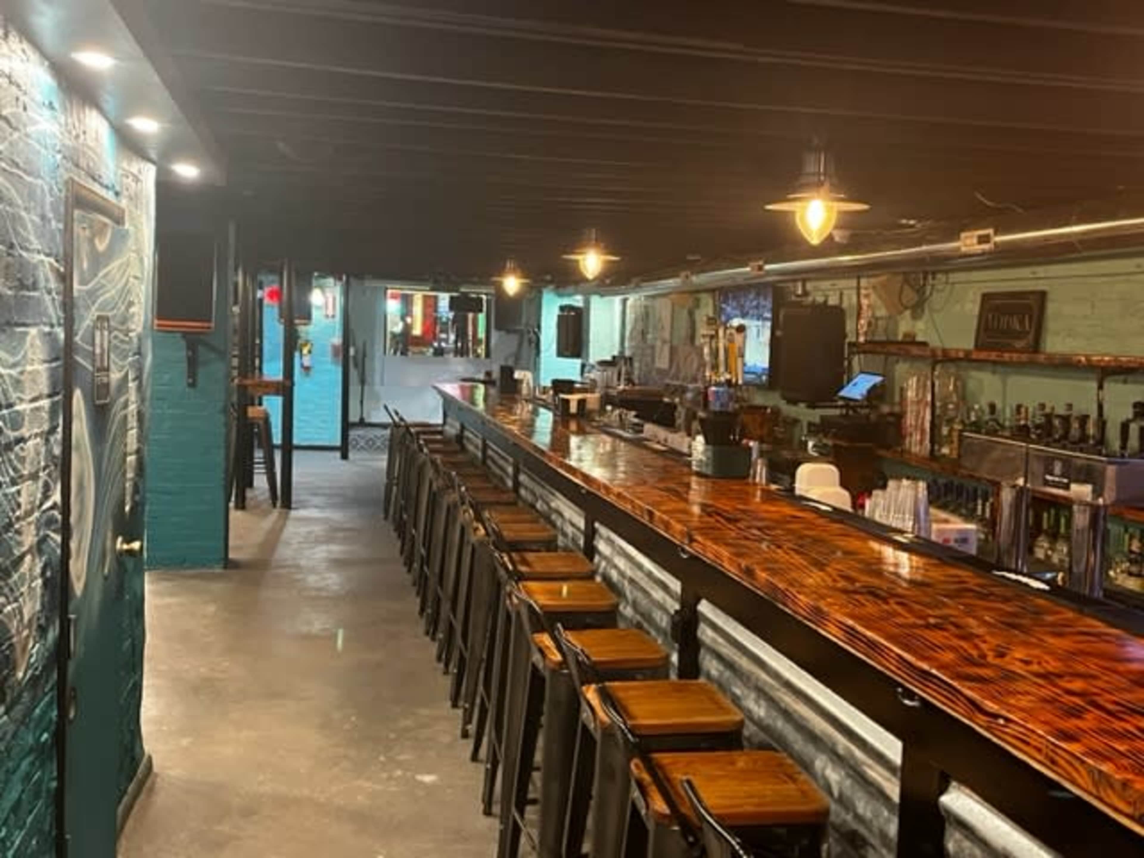 Rustic exposed brick bar with beautiful wall murals located in Adams ...