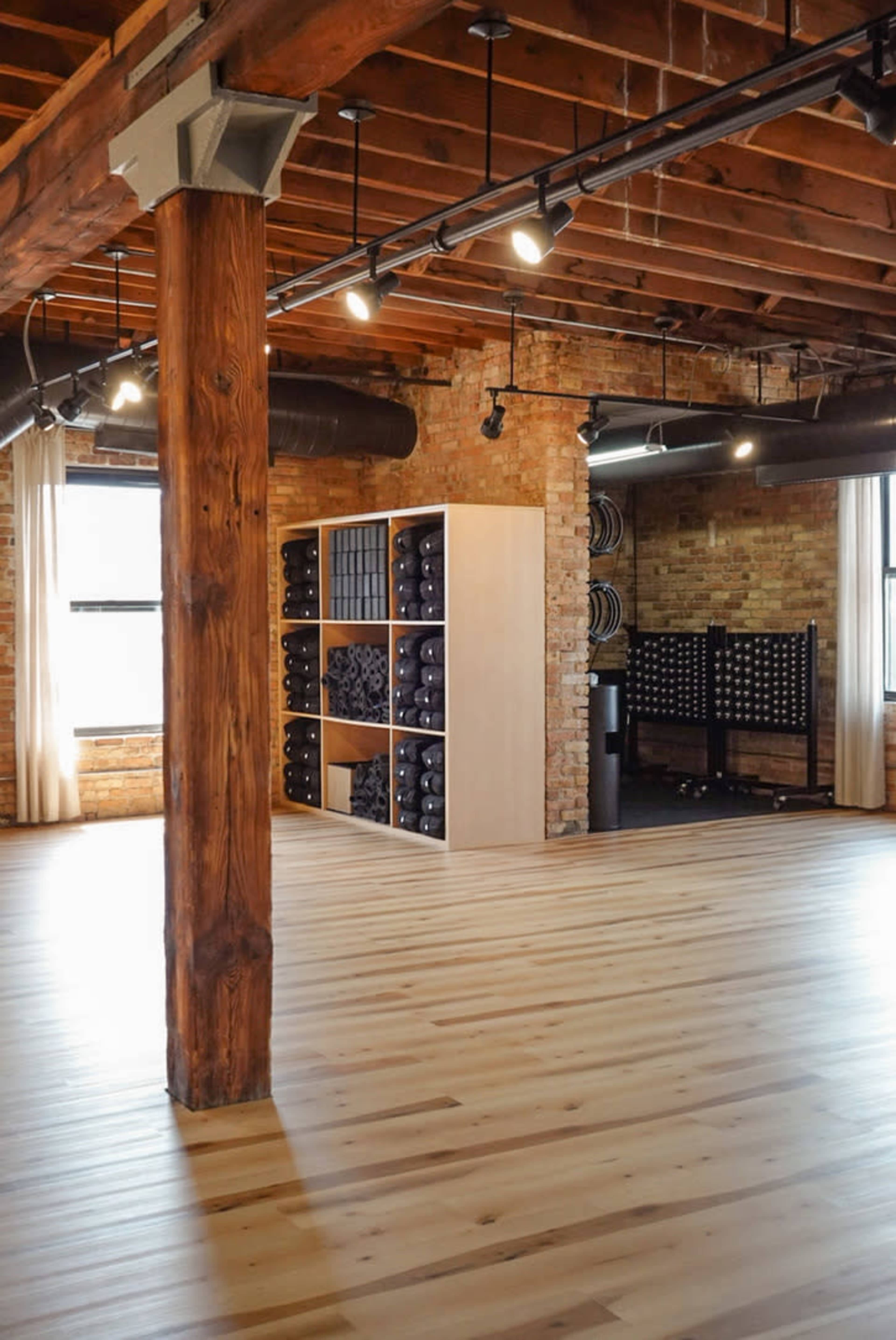 Beautiful timber loft fitness studio with equipment, skyline view and ...