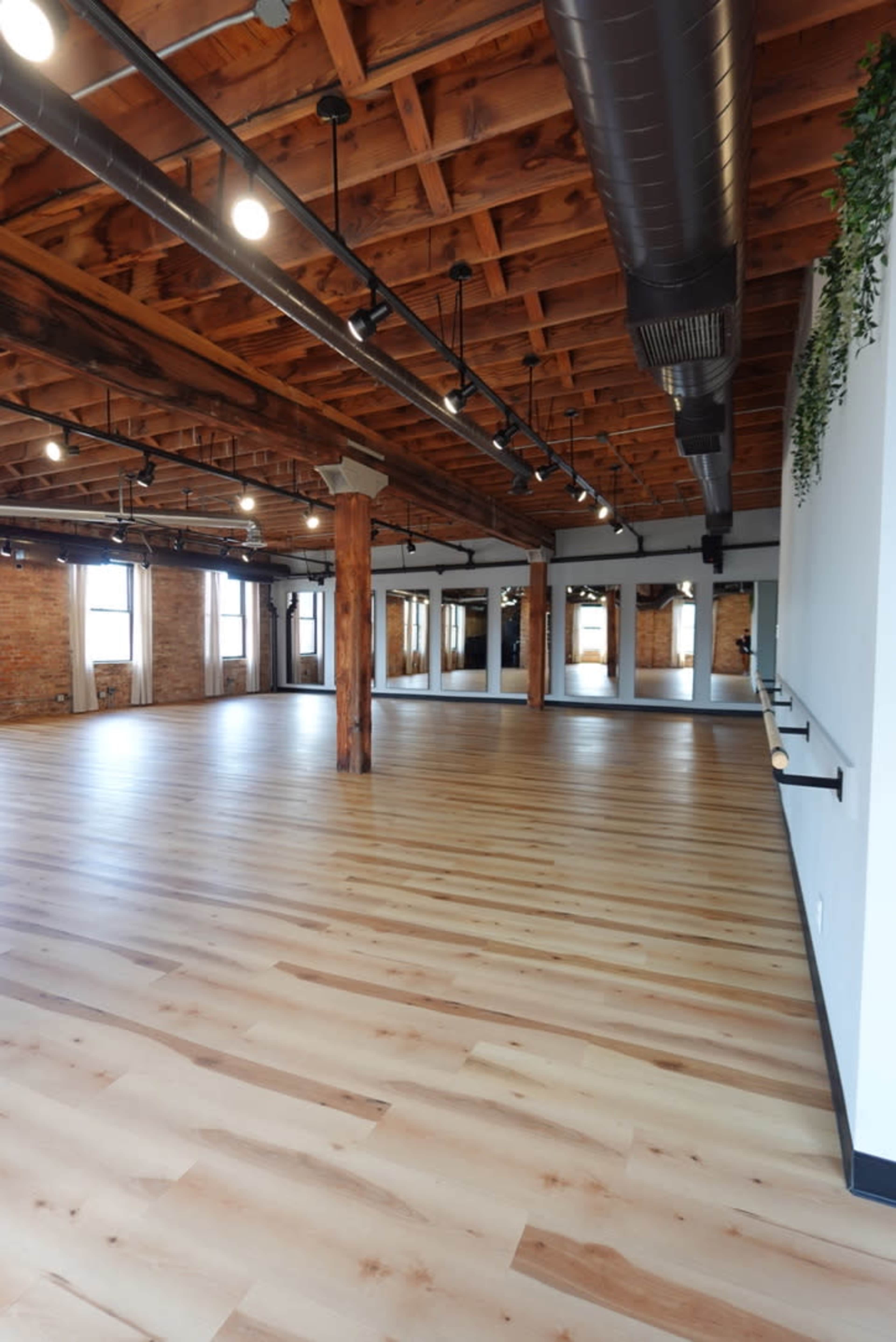 Beautiful timber loft fitness studio with equipment, skyline view and ...