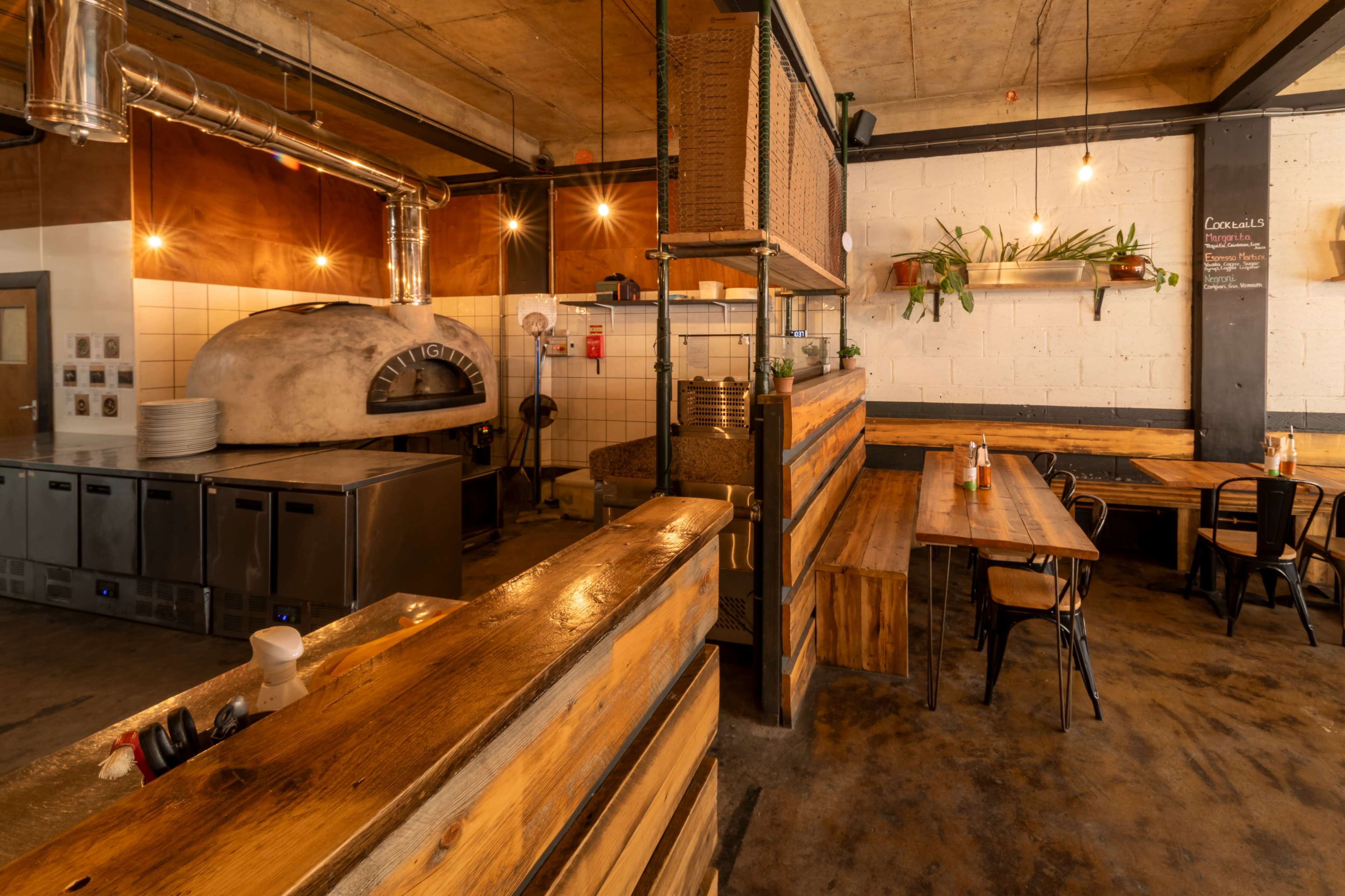 Rustic pizza restaurant with high exposed beam ceilings., London ...